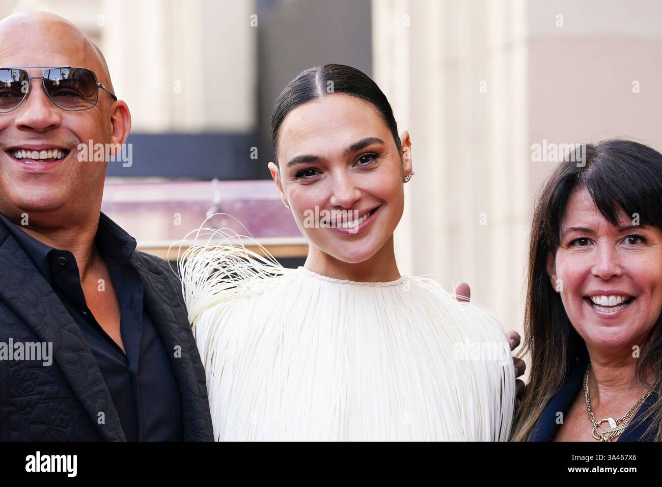 Vin Diesel, from left, Gal Gadot, and Patty Jenkins pose atop Gadot's new star at a ceremony on ...