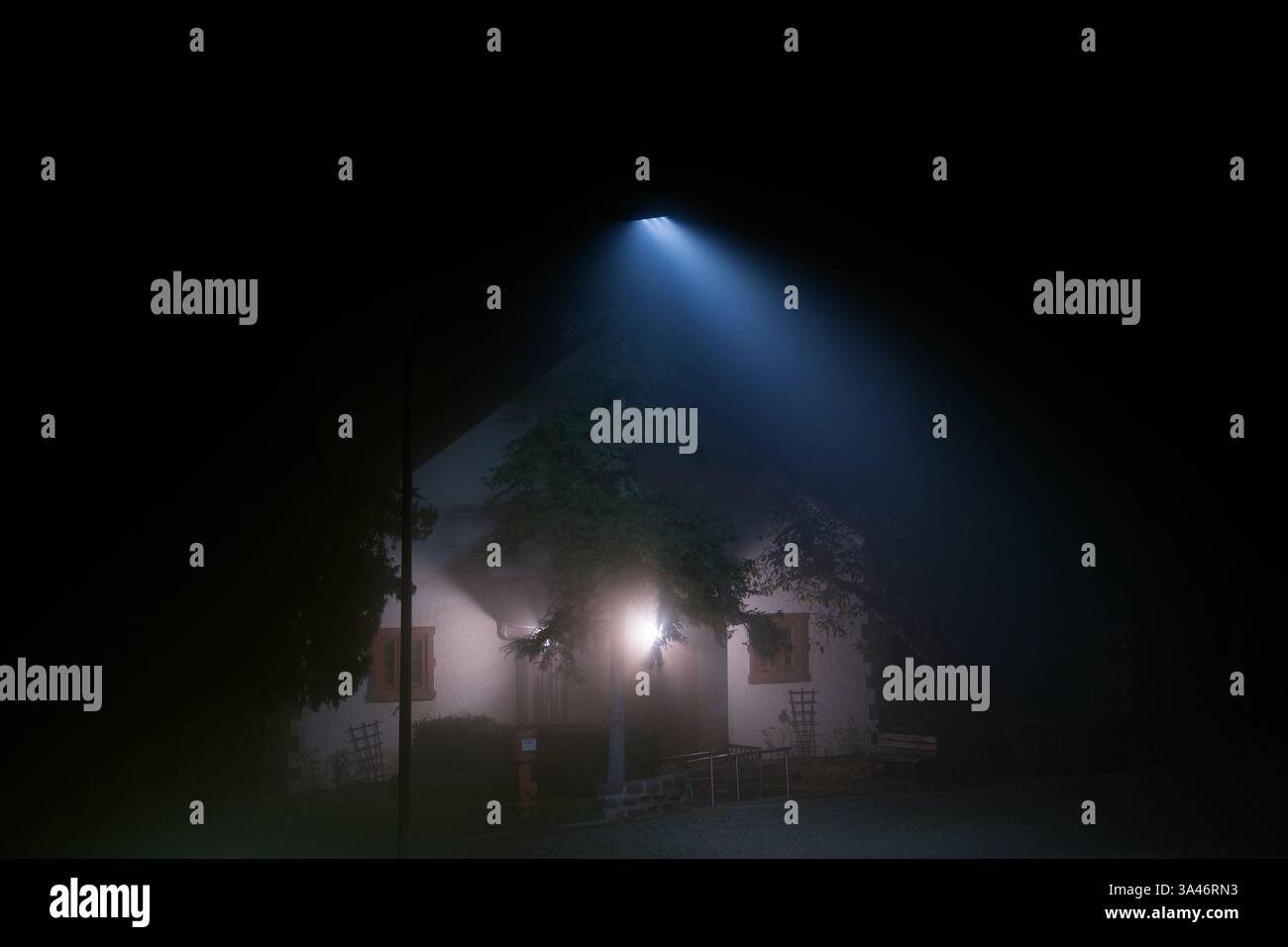 The one-story house is in total darkness, and only the rays of light ...