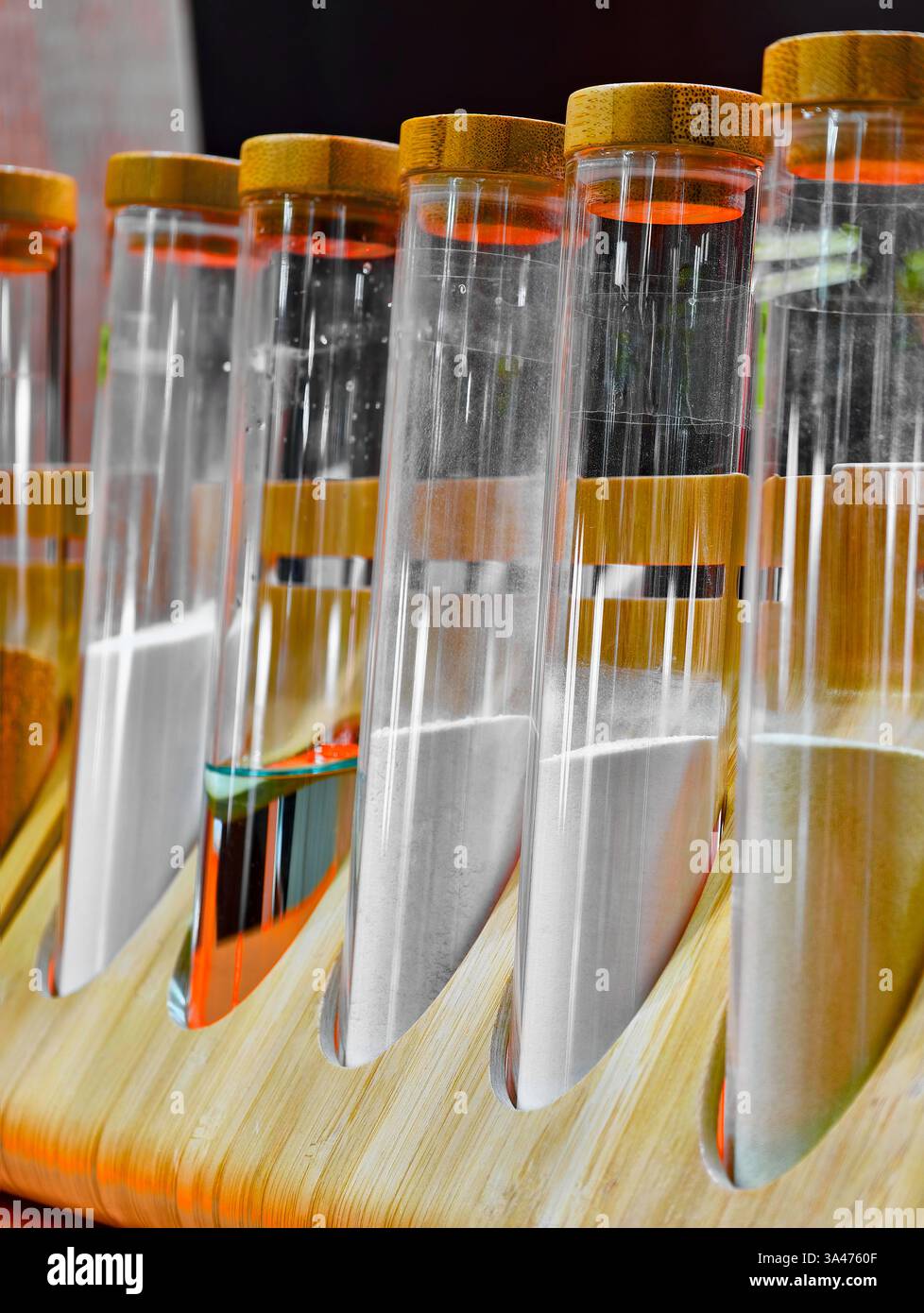 Colorful test tubes filled with various chemicals showcase scientific ...