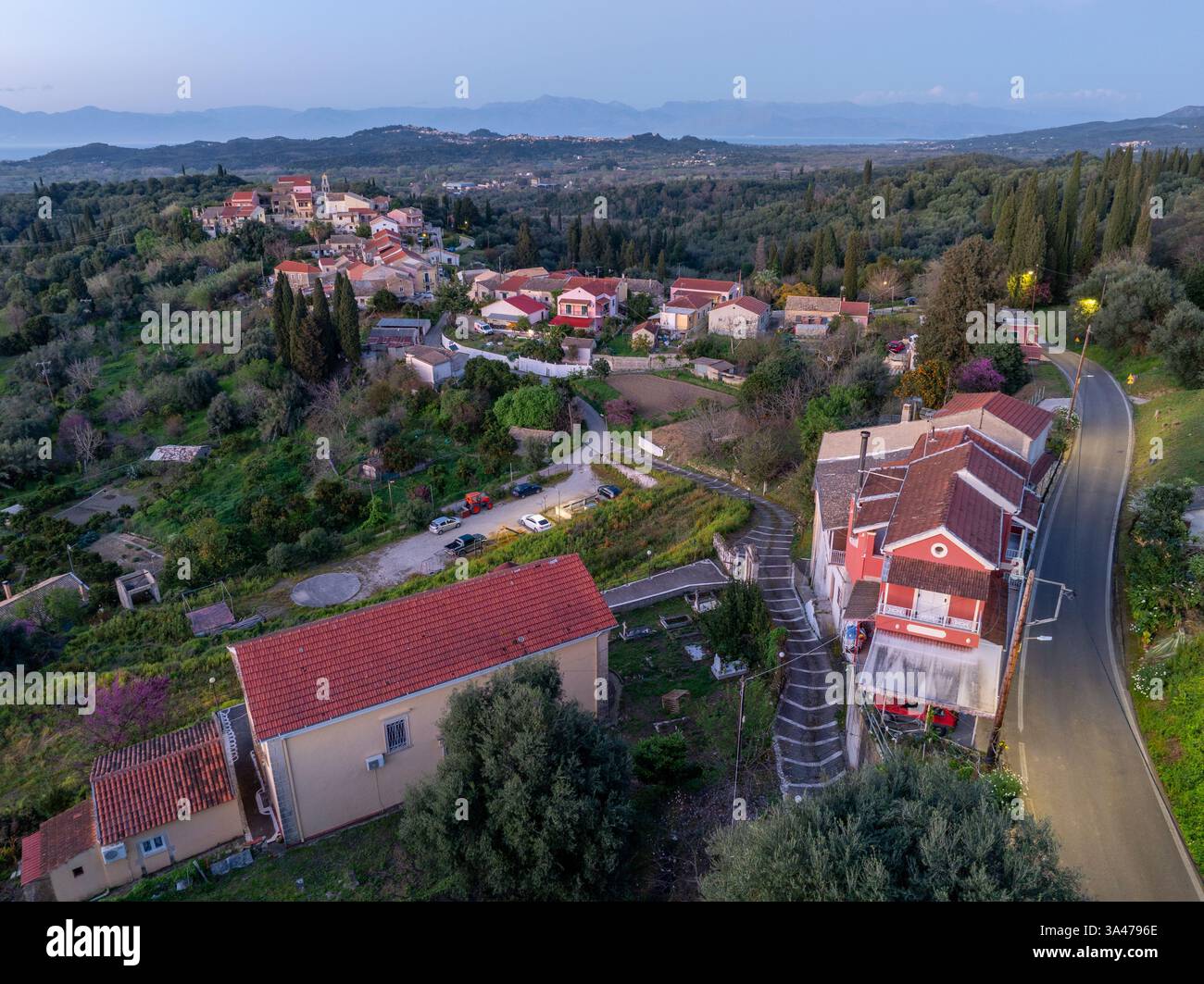 Aerial panorama of a picturesque village nestled in lush green hills ...
