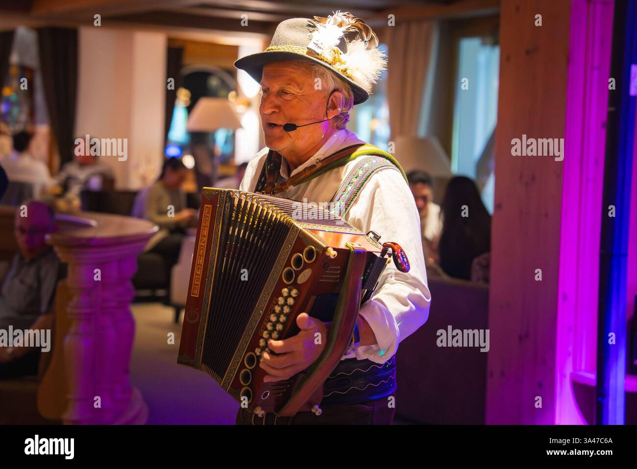 Man in Traditional Alpine Attire Playing Accordion Indoors Stock Photo ...