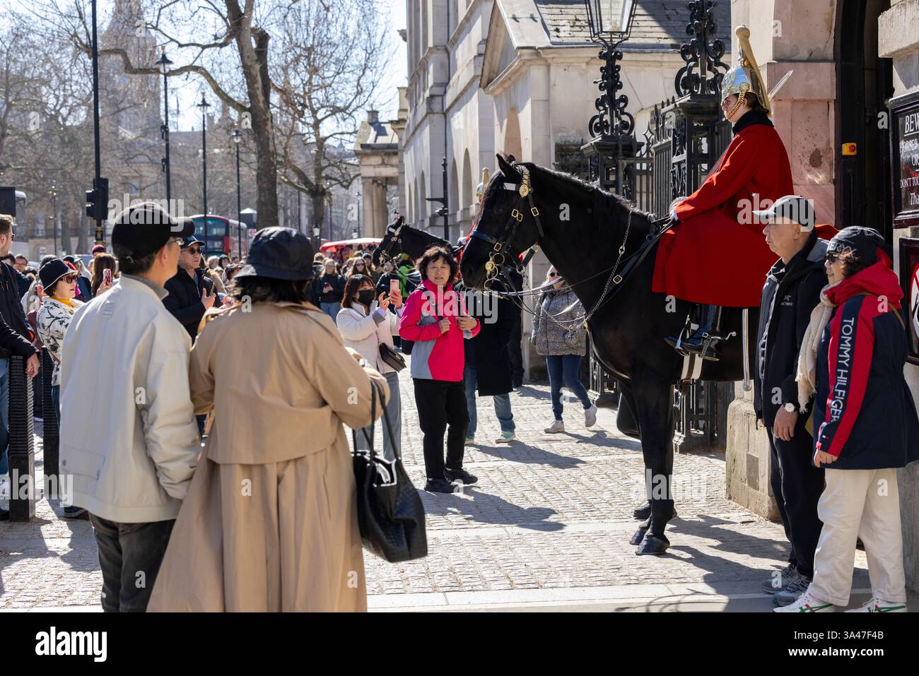 Tourists take photographs of The King's Life Guard, at the entrance to ...
