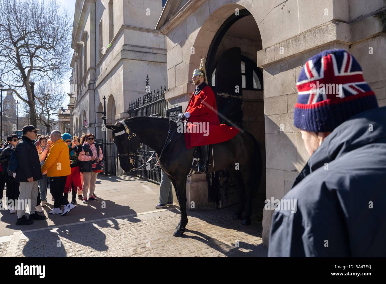 Tourists take photographs of The King's Life Guard, at the entrance to ...