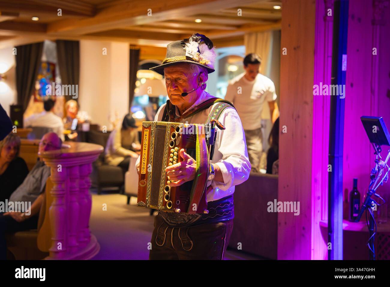 Man in Traditional Alpine Attire Playing Accordion Indoors Stock Photo ...