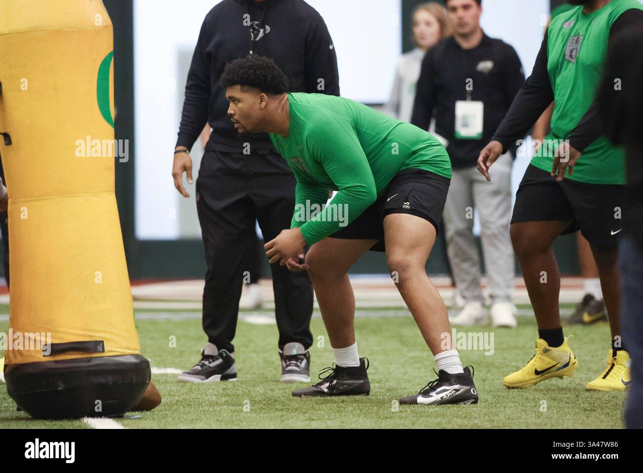 Oregon defensive lineman Derrick Harmon (55) runs a position drill at the school's NFL Pro Day ...