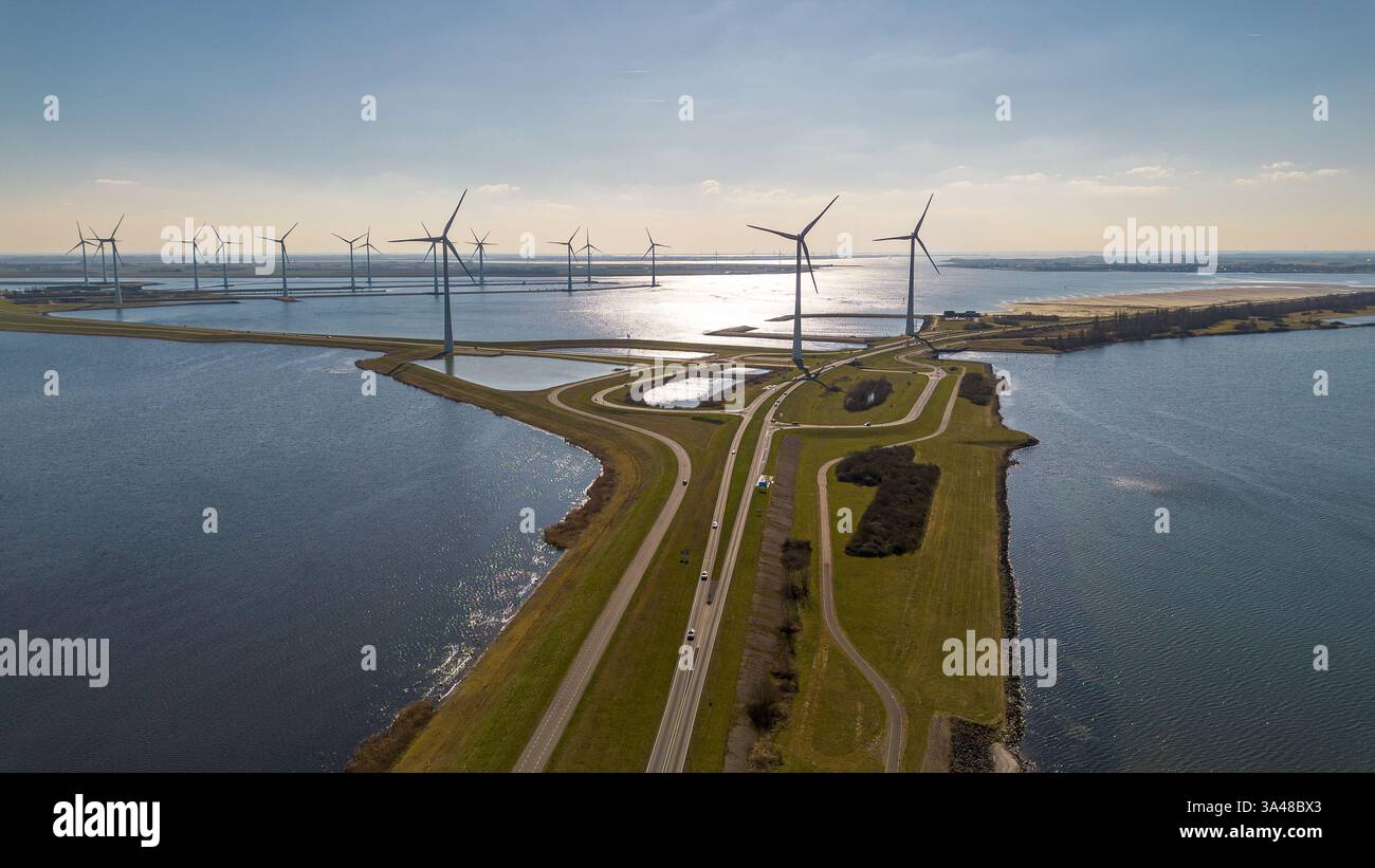 A scenic aerial view of a coastal wind farm with multiple wind turbines ...