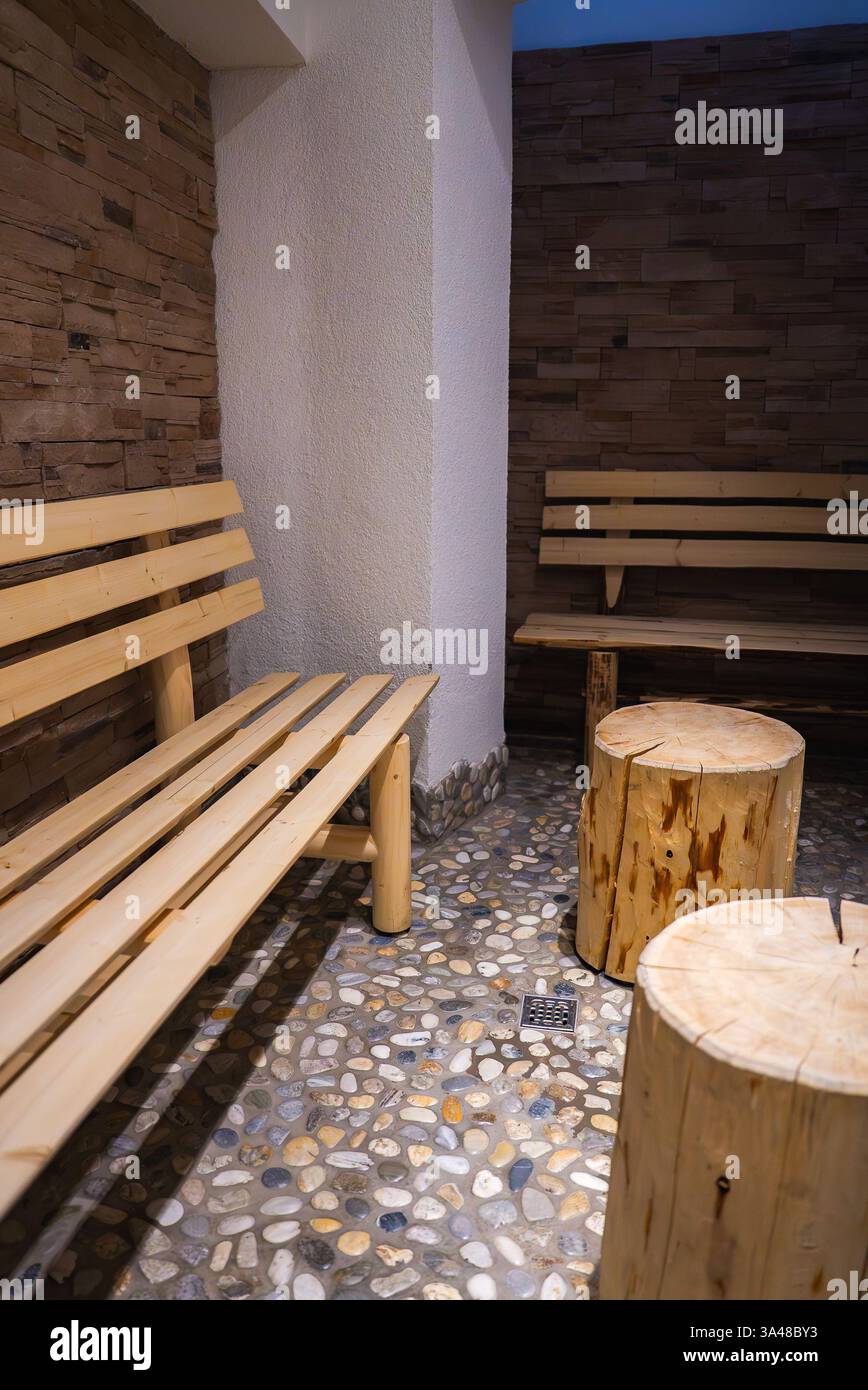 Rustic Indoor Seating Area with Wooden Benches and Stone Details Stock ...