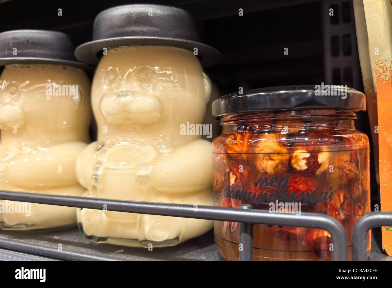 A charming bear-shaped container filled with liquid sits beside a glass ...