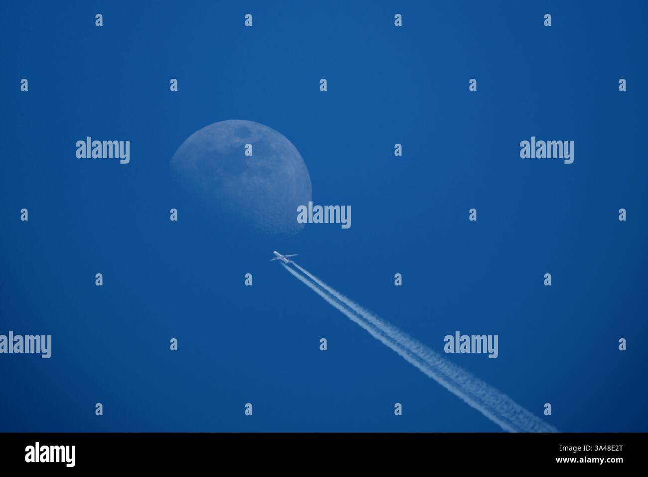 moon and airplane in the blue sky Stock Photo - Alamy