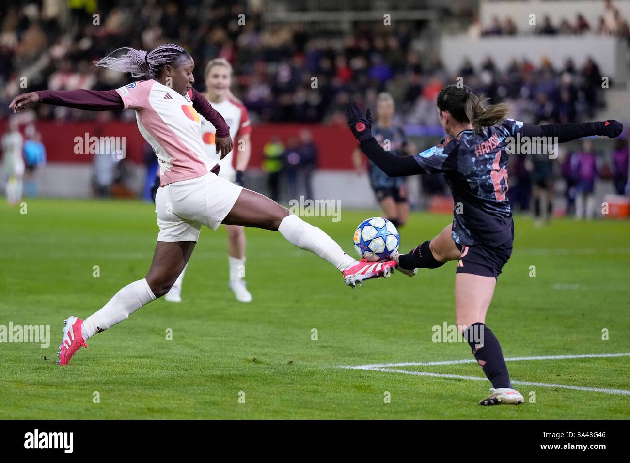 Lyon's Kadidiatou Diani, left, vies for the ball with Bayern's Tuva ...