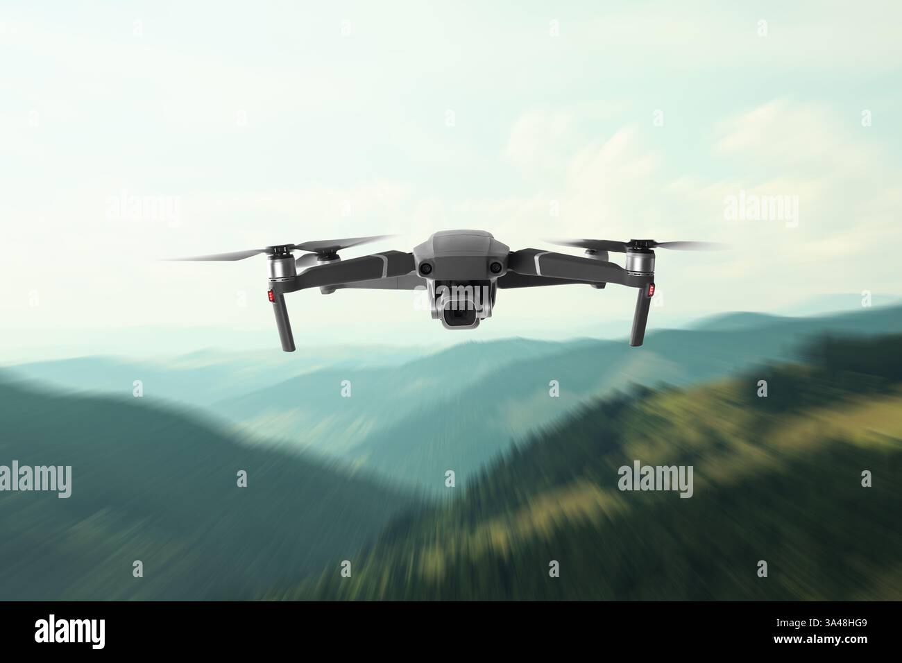 Drone with camera flying in mountains. Unmanned aerial vehicle for ...