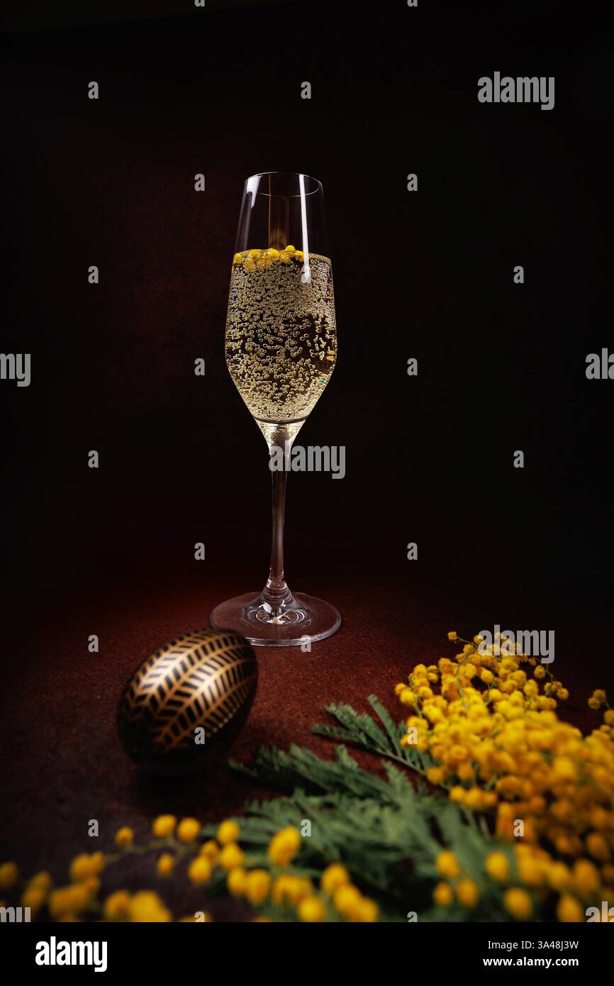 Easter champagne with floating mimosa and decorative eggs Stock Photo ...
