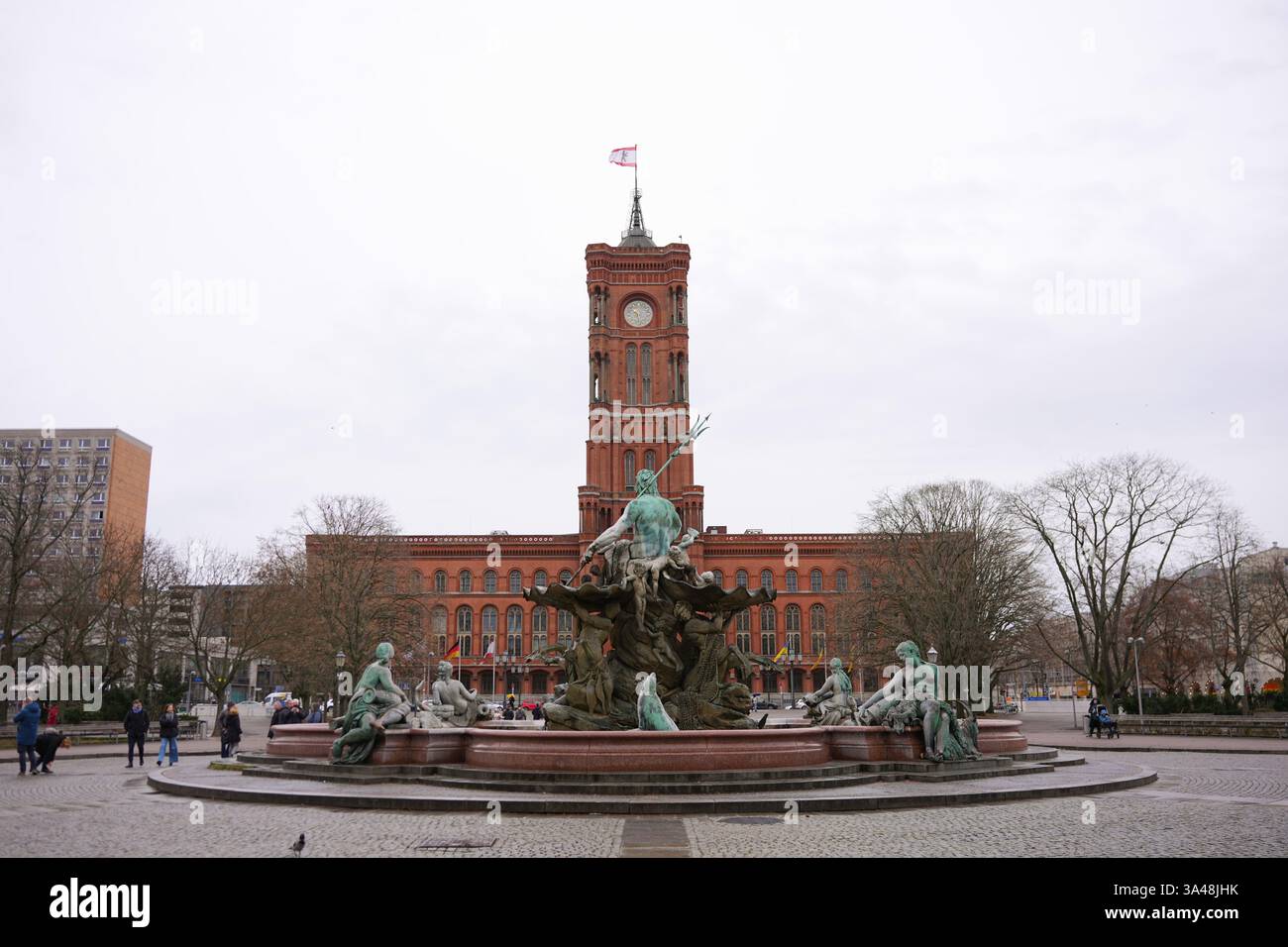 Berlin, Germany 02.13.2025 Historic fountain and red-brick clock tower ...