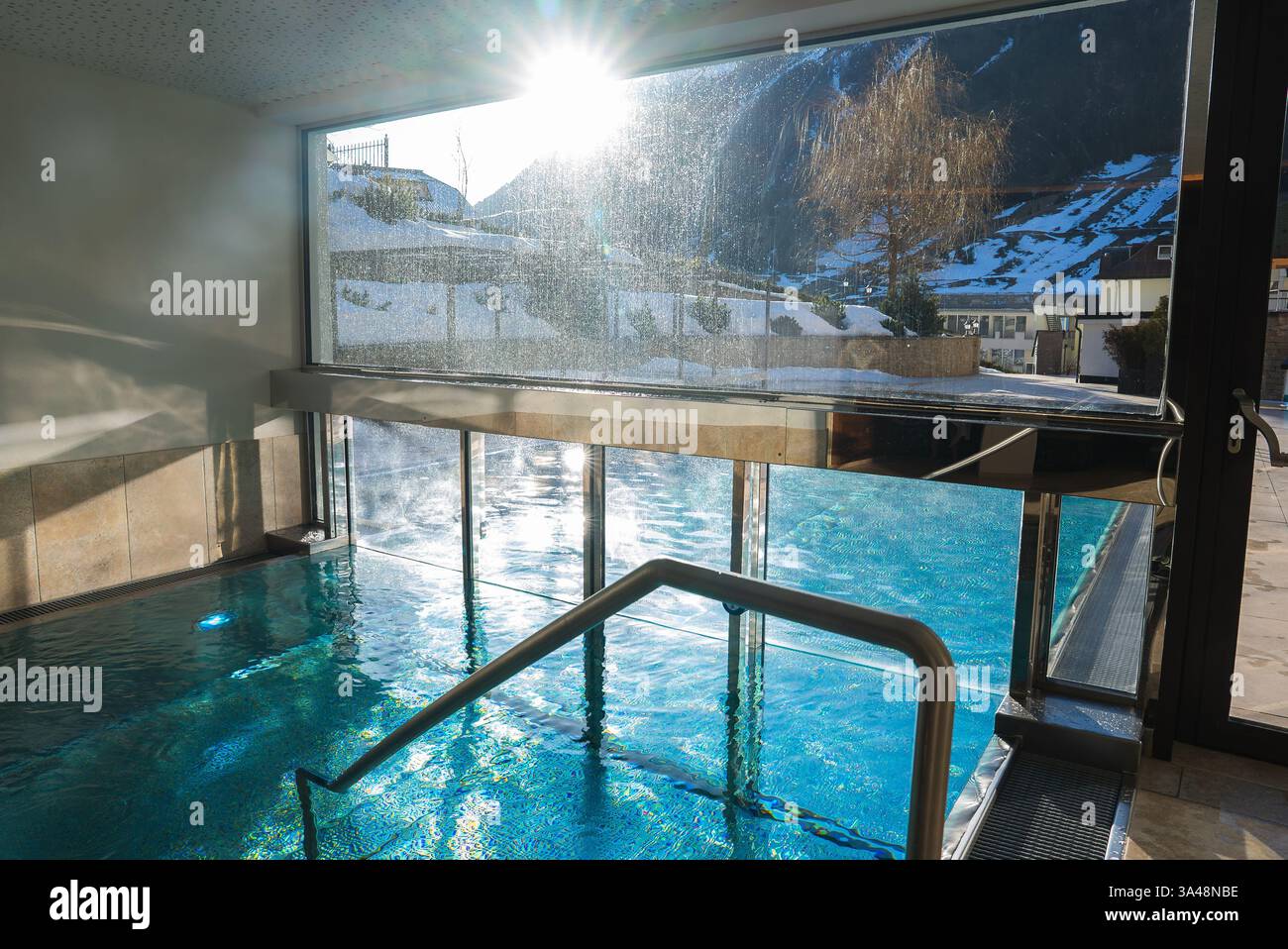 Indoor Pool with Glass Windows Overlooking Snowy Mountains in Ischgl ...