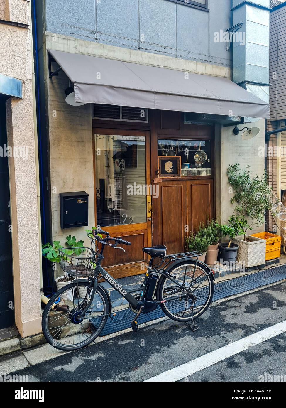 Exterior of a small restaurant bar in Asakusa, Tokyo with a bicycle ...