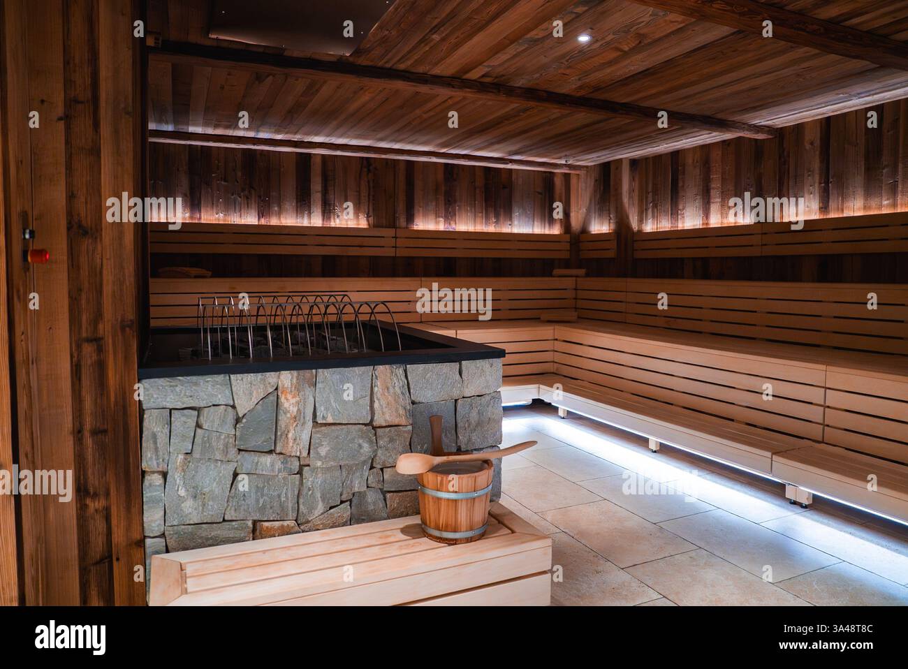 Luxurious Sauna Interior with Wooden Walls and Central Stone Structure ...