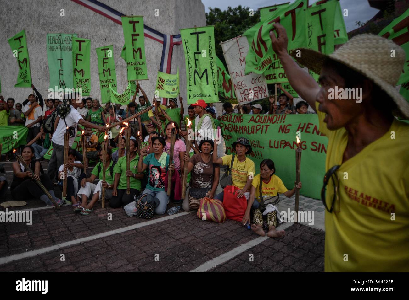 June 7, 2014 - Quezon, Philippines - Farmers light torches as they ...