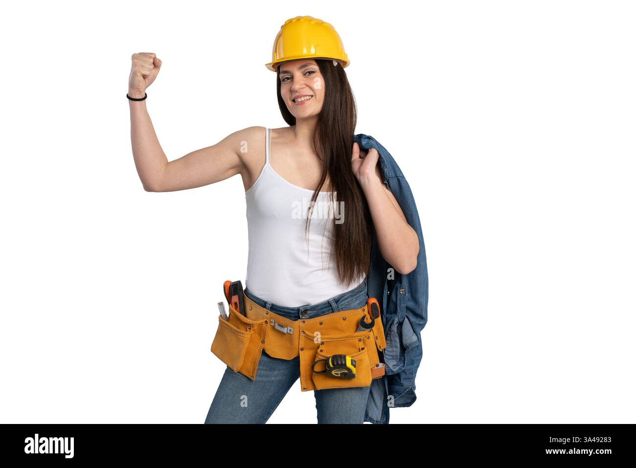 A strong and confident female construction worker in a hard hat and ...