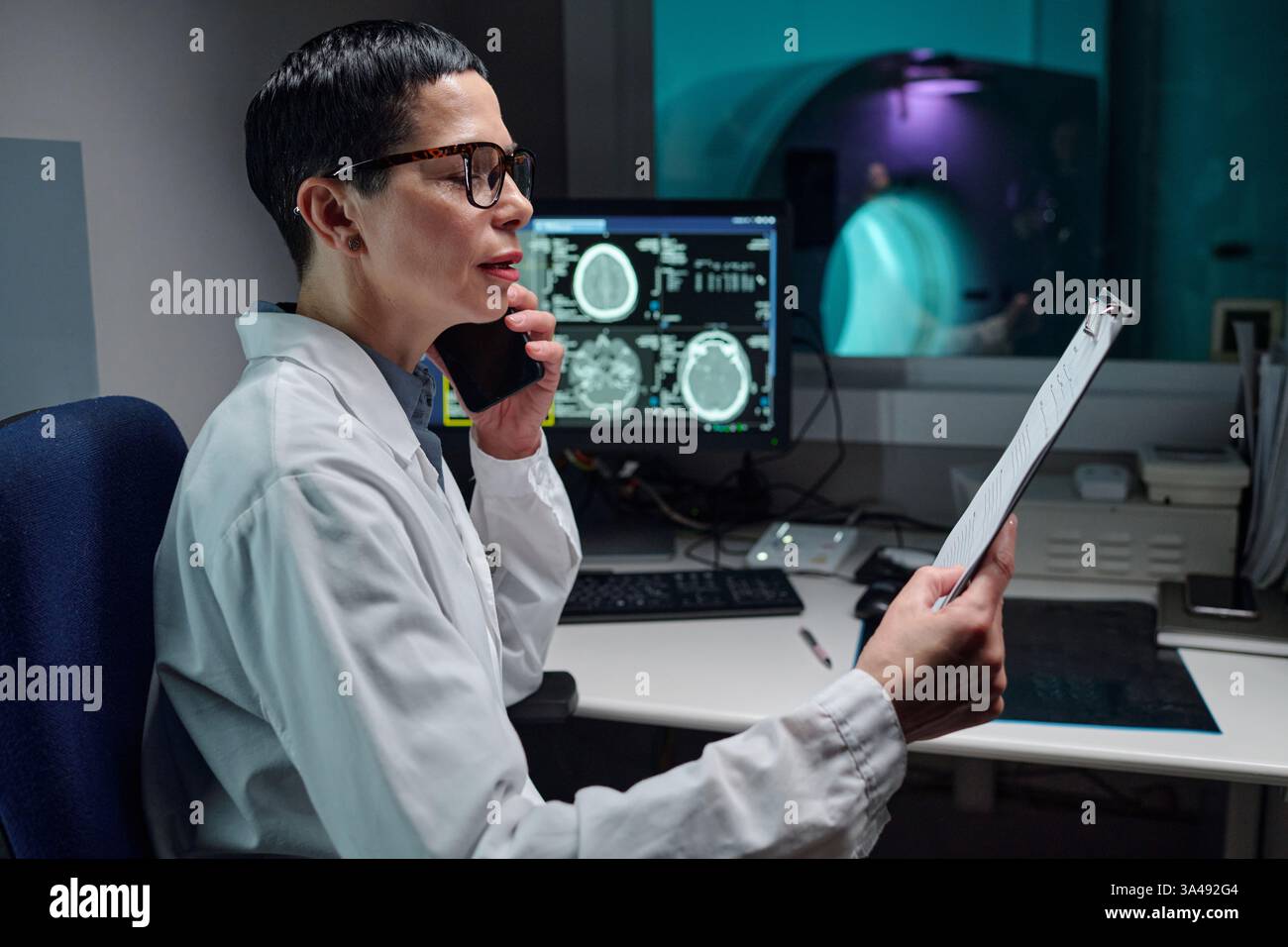 Medical professional in white lab coat analyzing diagnostic imaging ...