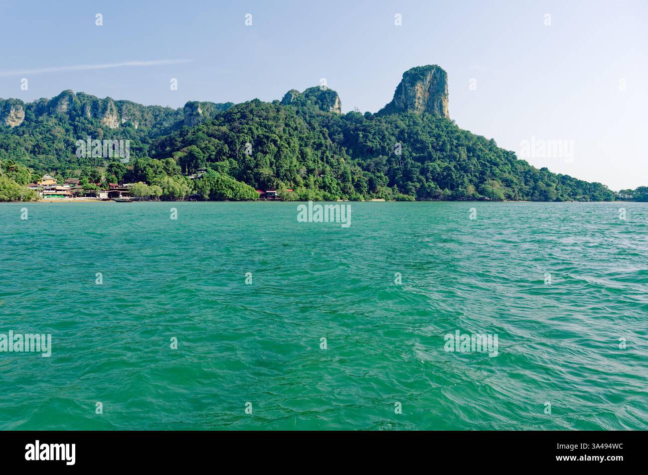 East Railay, its lush limestone cliffs, dense tropical forest, and ...