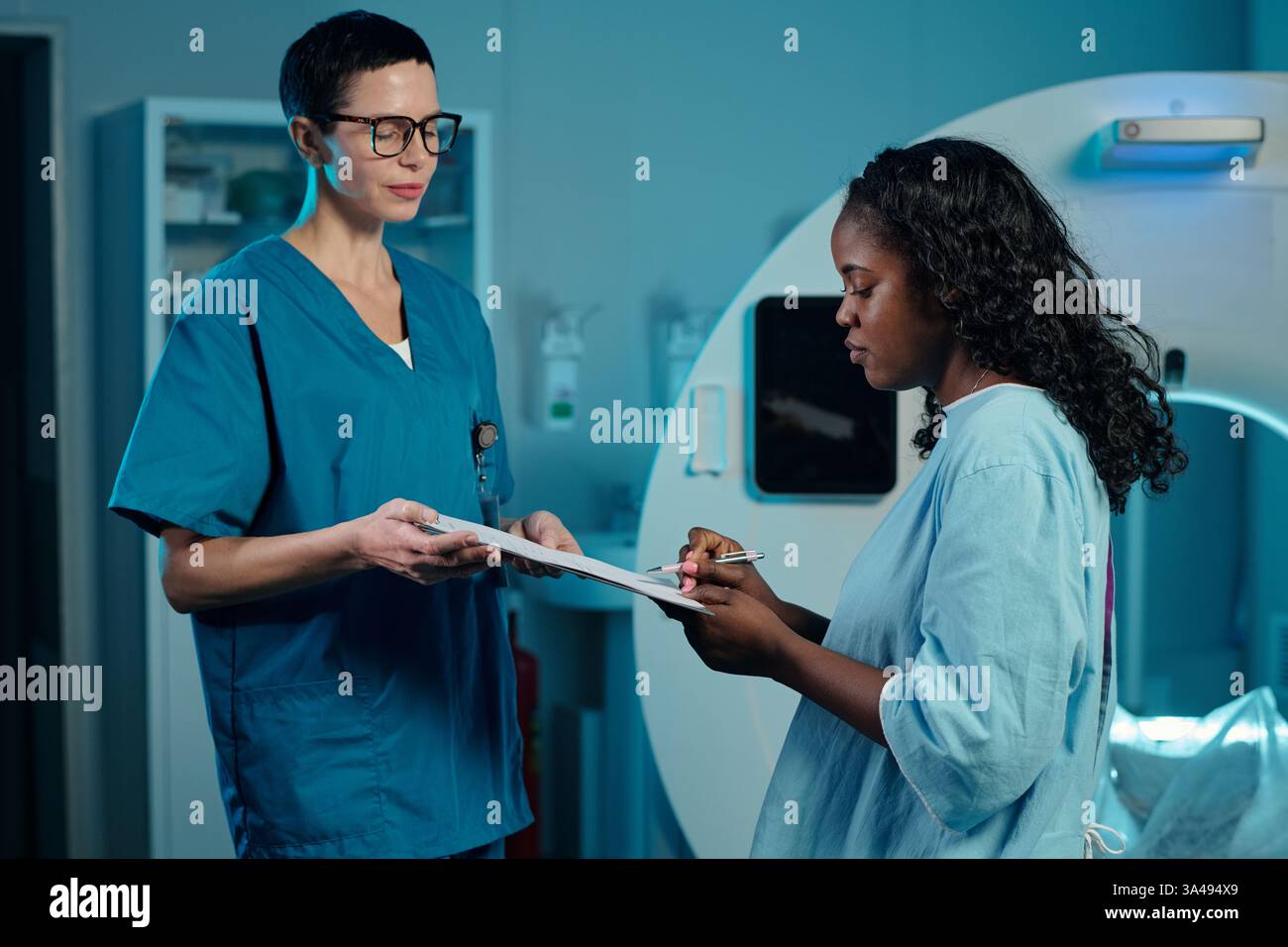 Healthcare professionals in medical facility reviewing patient charts ...