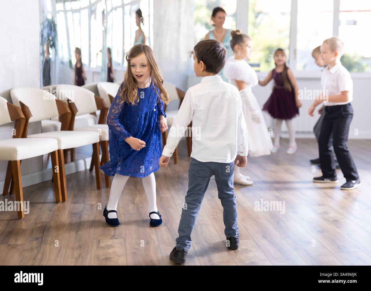 Preteen girl dancing twist with classmates during school party Stock ...