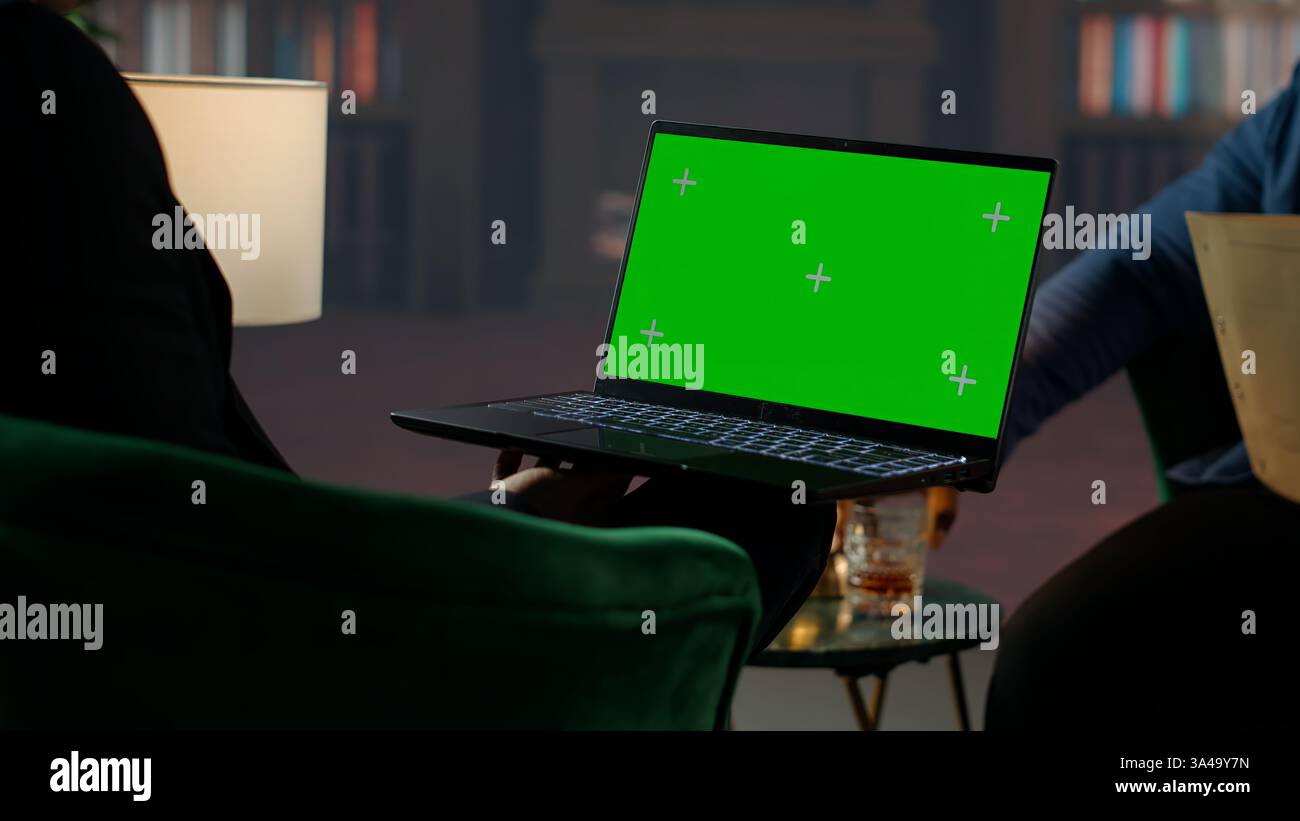 Two secret agents examine case details at CIA safe house with a mockup ...