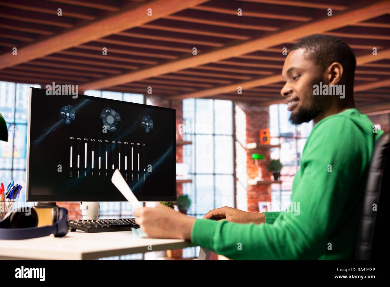 Smiling man in home office using financial application UI on PC screen ...