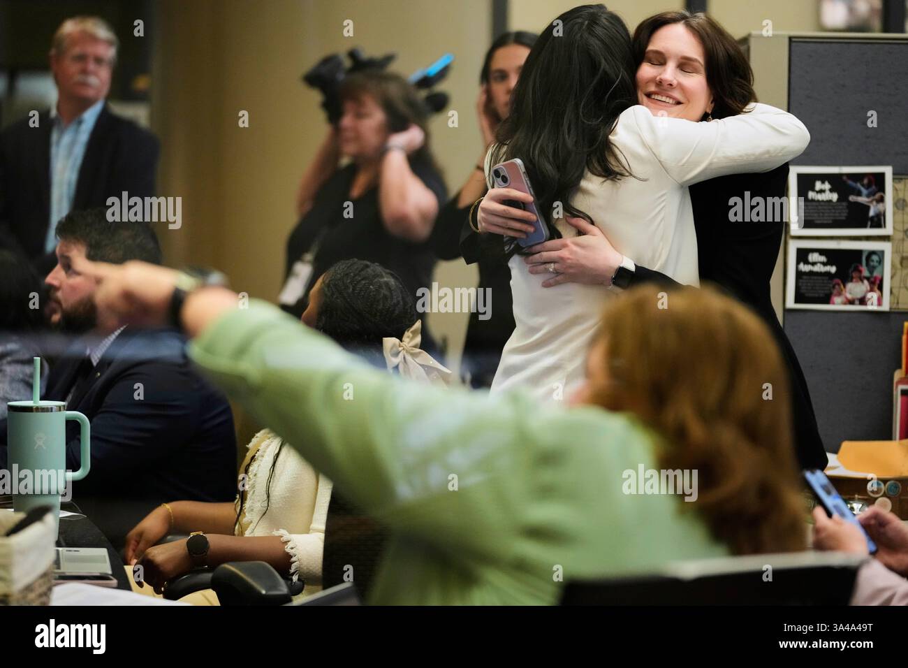 NASA employees react on Tuesday, March 18, 2025, in Houston after ...
