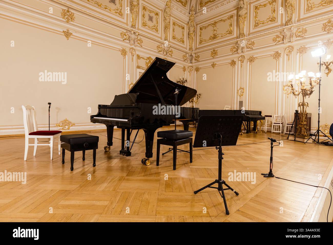 Piano at concert hall stage Stock Photo - Alamy