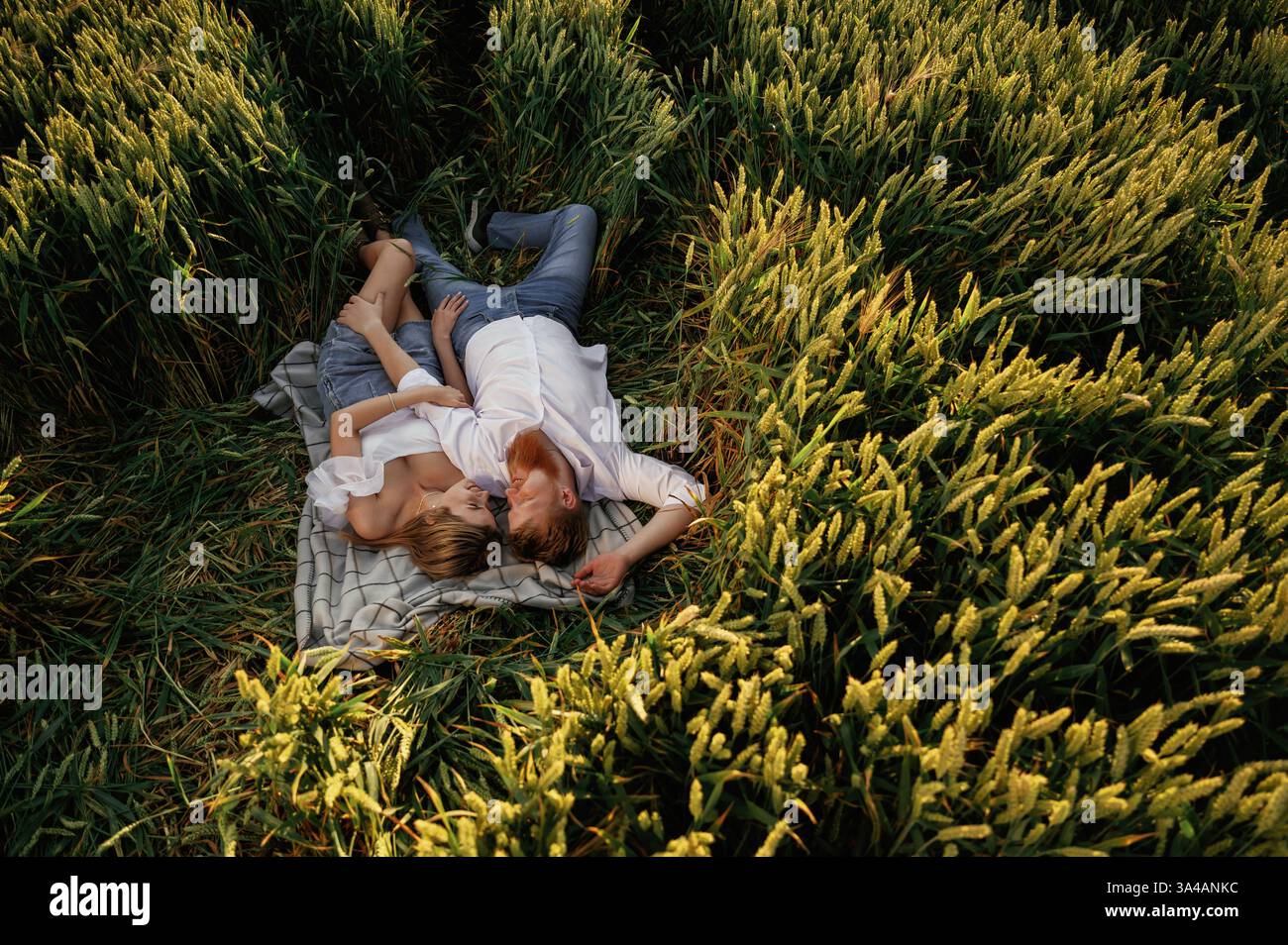 Resting, lying down, top view. Lovely couple are on the green ...