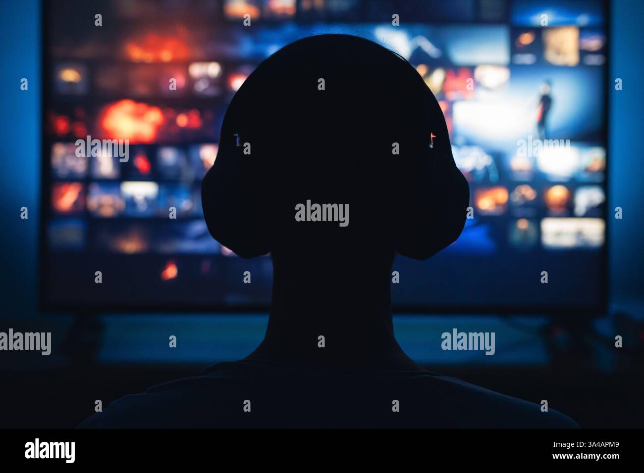 Man looks at television screen to choose movie Stock Photo - Alamy