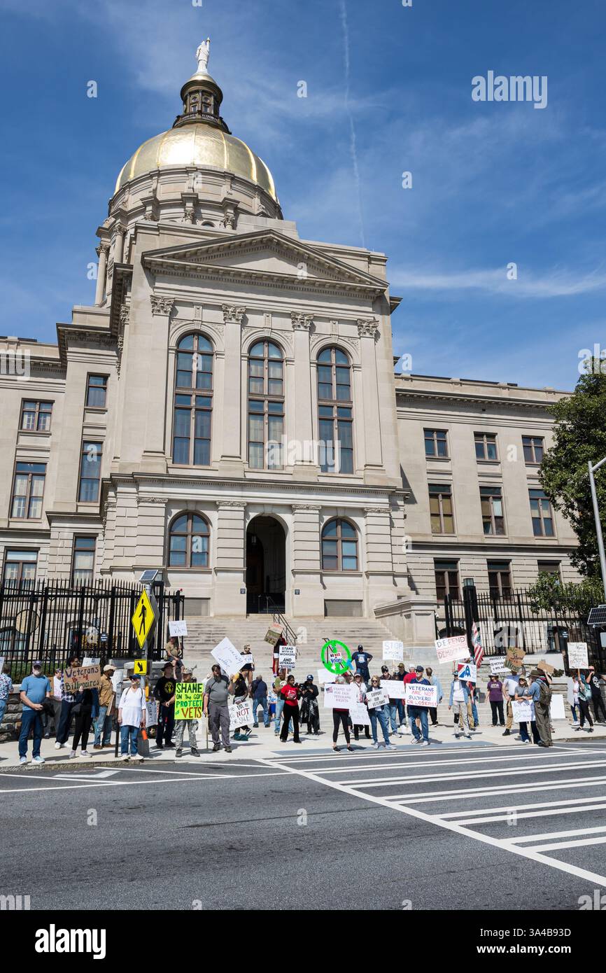 Atlanta, GA / USA - March 14, 2025: Vertical shot group holding signs ...