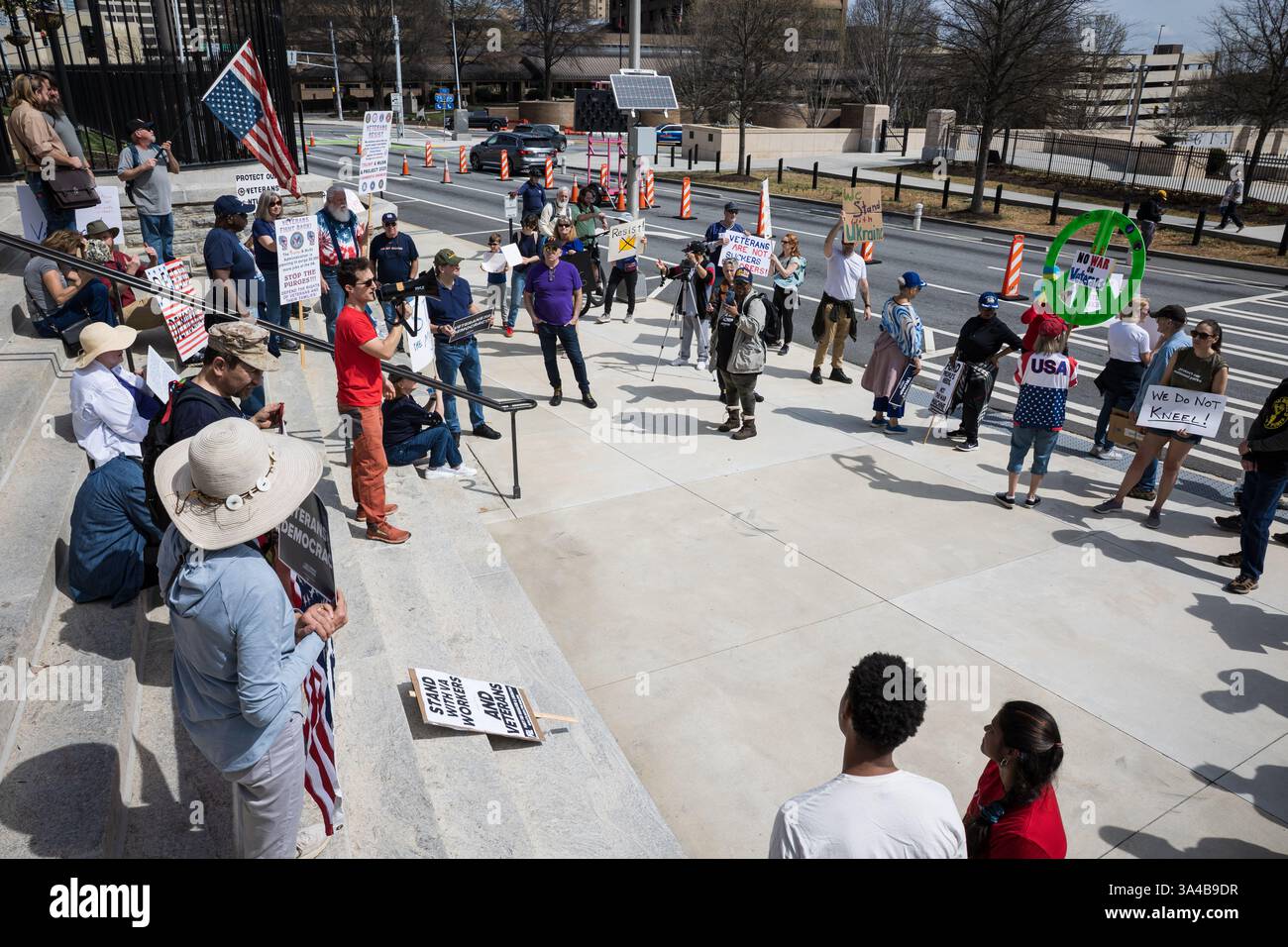 Atlanta, GA / USA - March 14, 2025: Wide shot shows activists listening ...