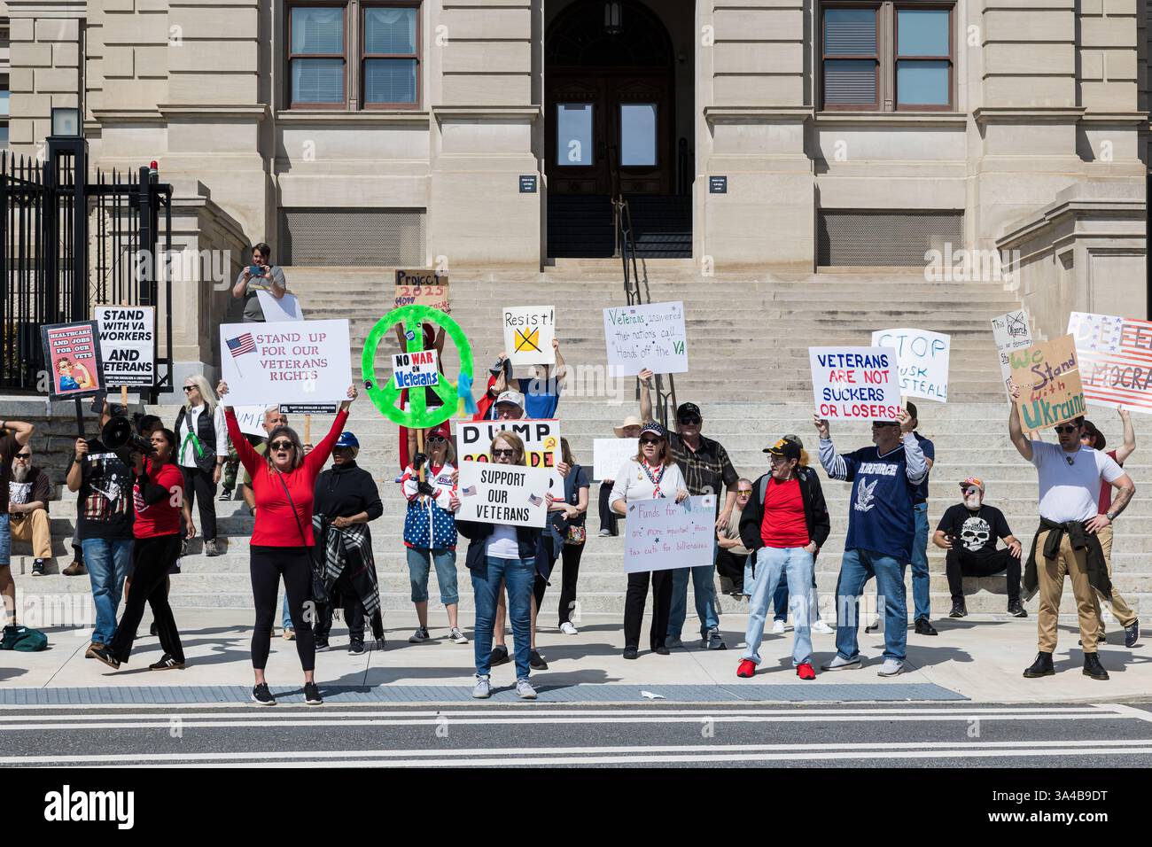 Atlanta, GA / USA - March 14, 2025: People hold up signs to protest ...