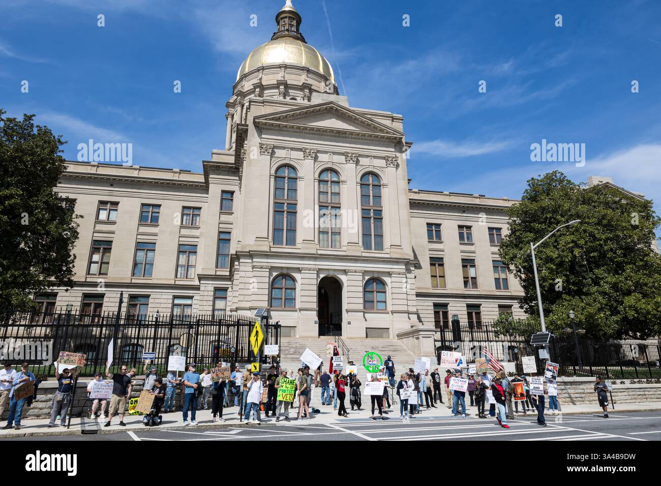 Atlanta, GA / USA - March 14, 2025: Wide shot of people signs to ...