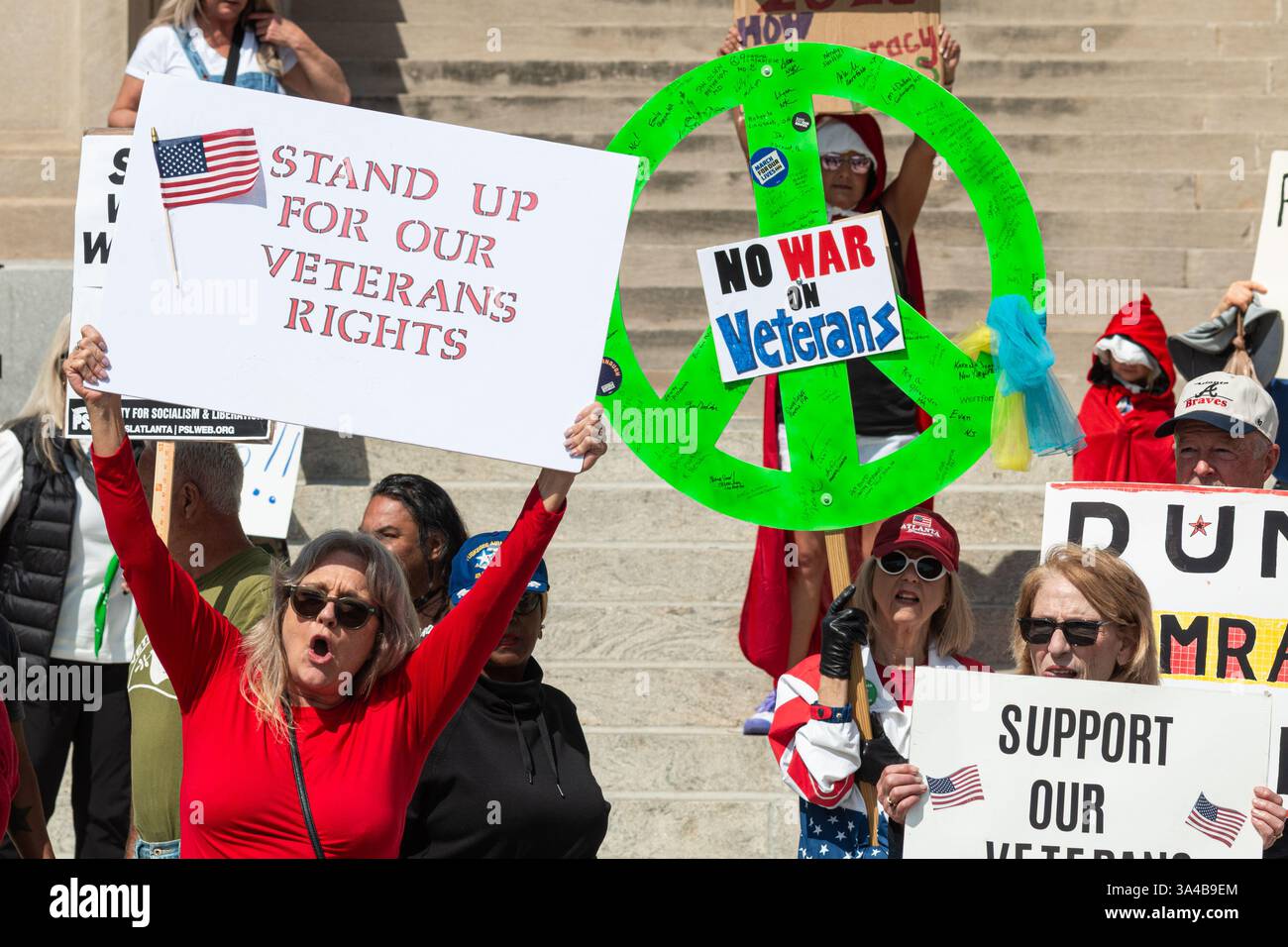 Atlanta, GA / USA - March 14, 2025: Women hold up signs to protest ...