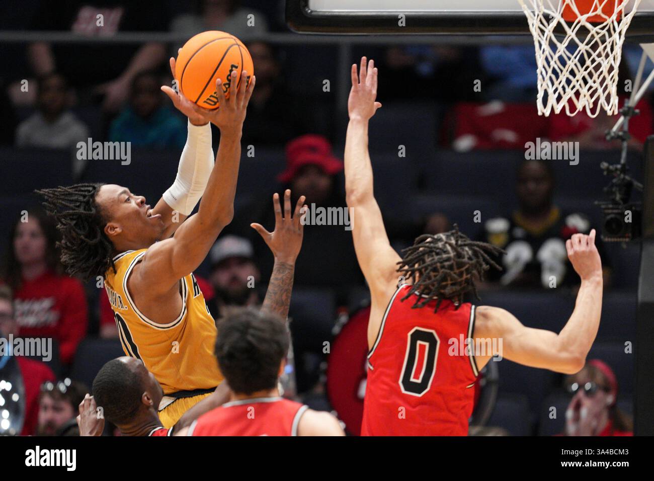 Alabama State guard TJ Madlock, left, shoots against Saint Francis ...