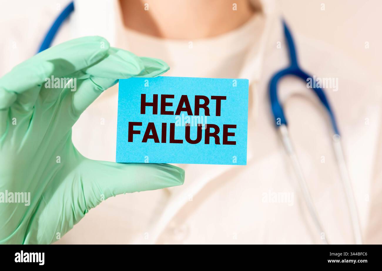 Doctor's hands in blue gloves shows the word heart failure. Medical ...