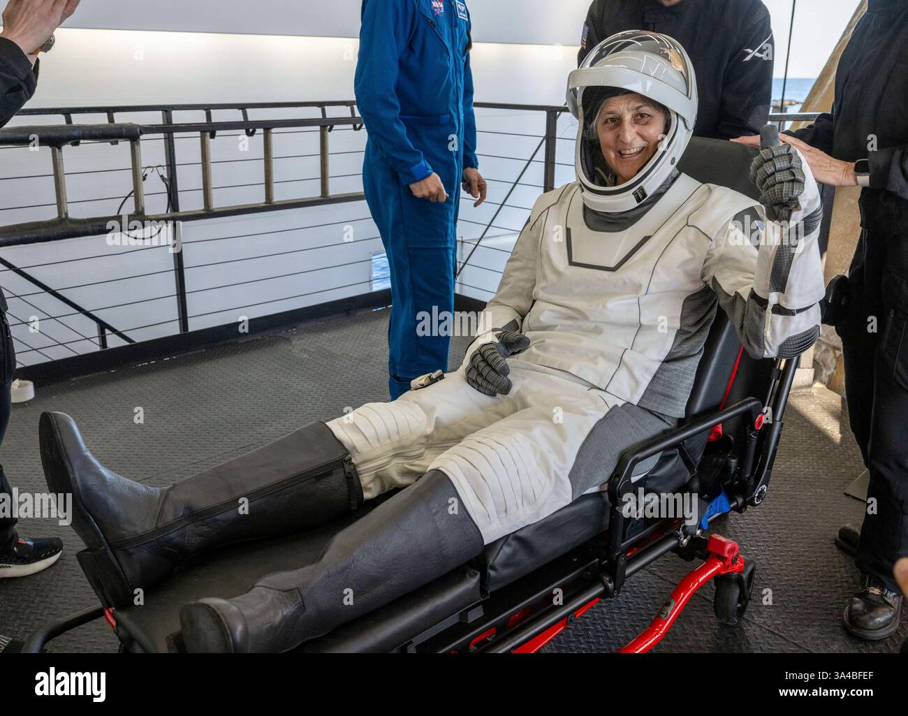 NASA astronaut Suni Williams gives a thumbs-up after being helped out ...