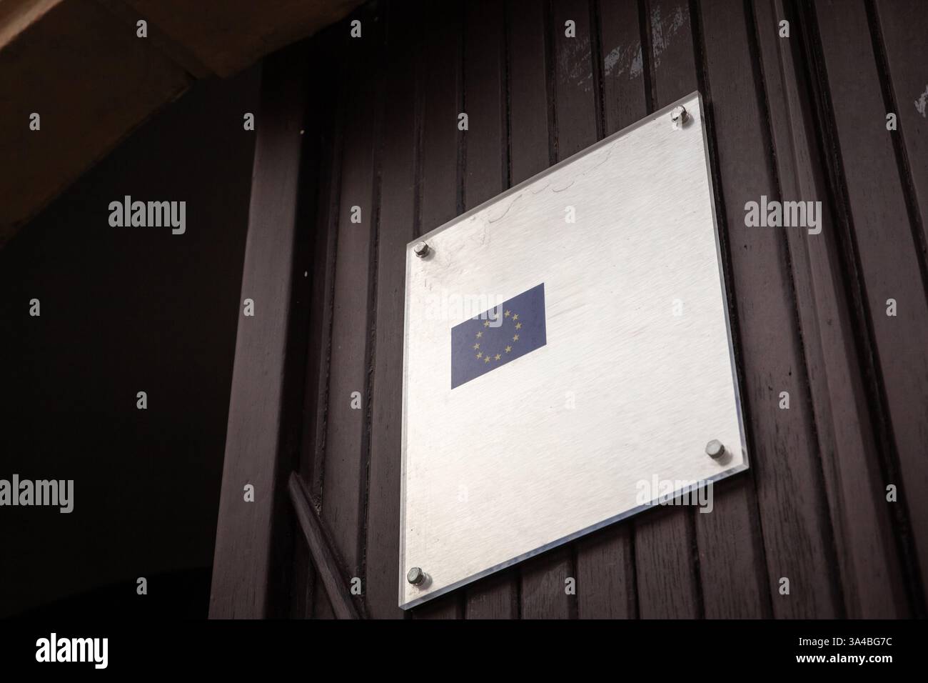 Metal plaque featuring the European Union flag on a building's entrance ...