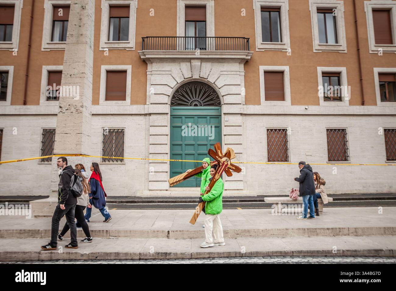 VATICAN - JANUARY 15, 2025: Pilgrims carrying wooden crosses during a ...