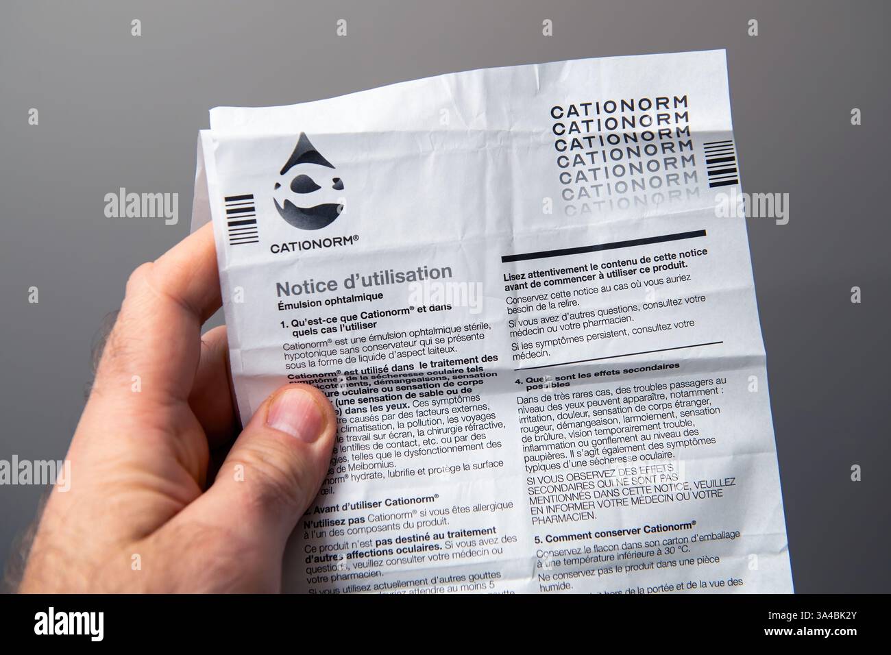 Paris, France - Mar 10, 2025: A male hand holds a Cationorm ophthalmic ...