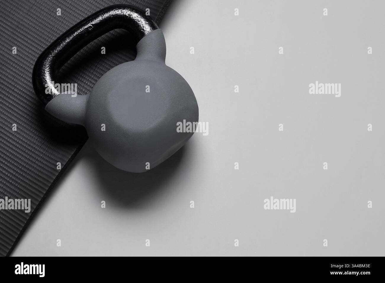 Kettlebell and mat on grey background, top view. Space for text Stock ...