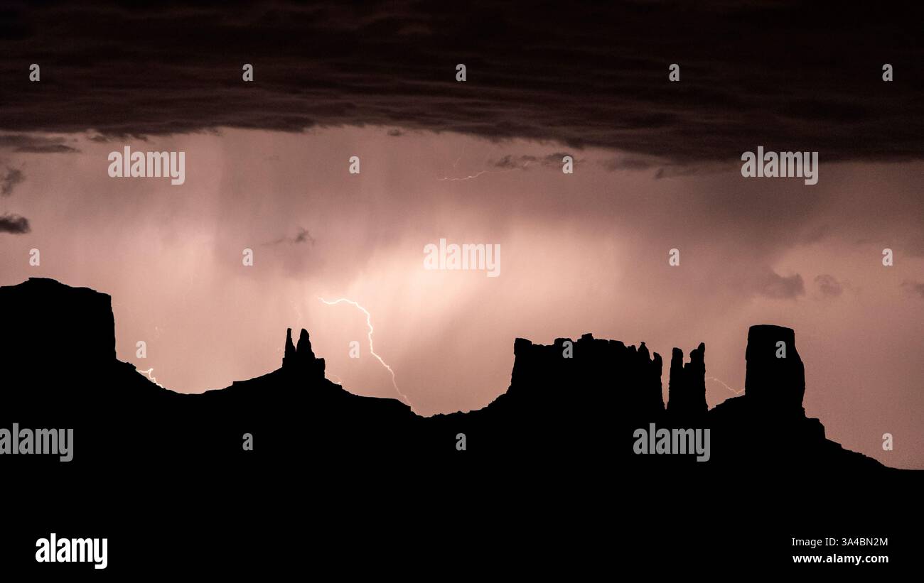 The iconic monument valley silhouetted with lightning strike Stock ...