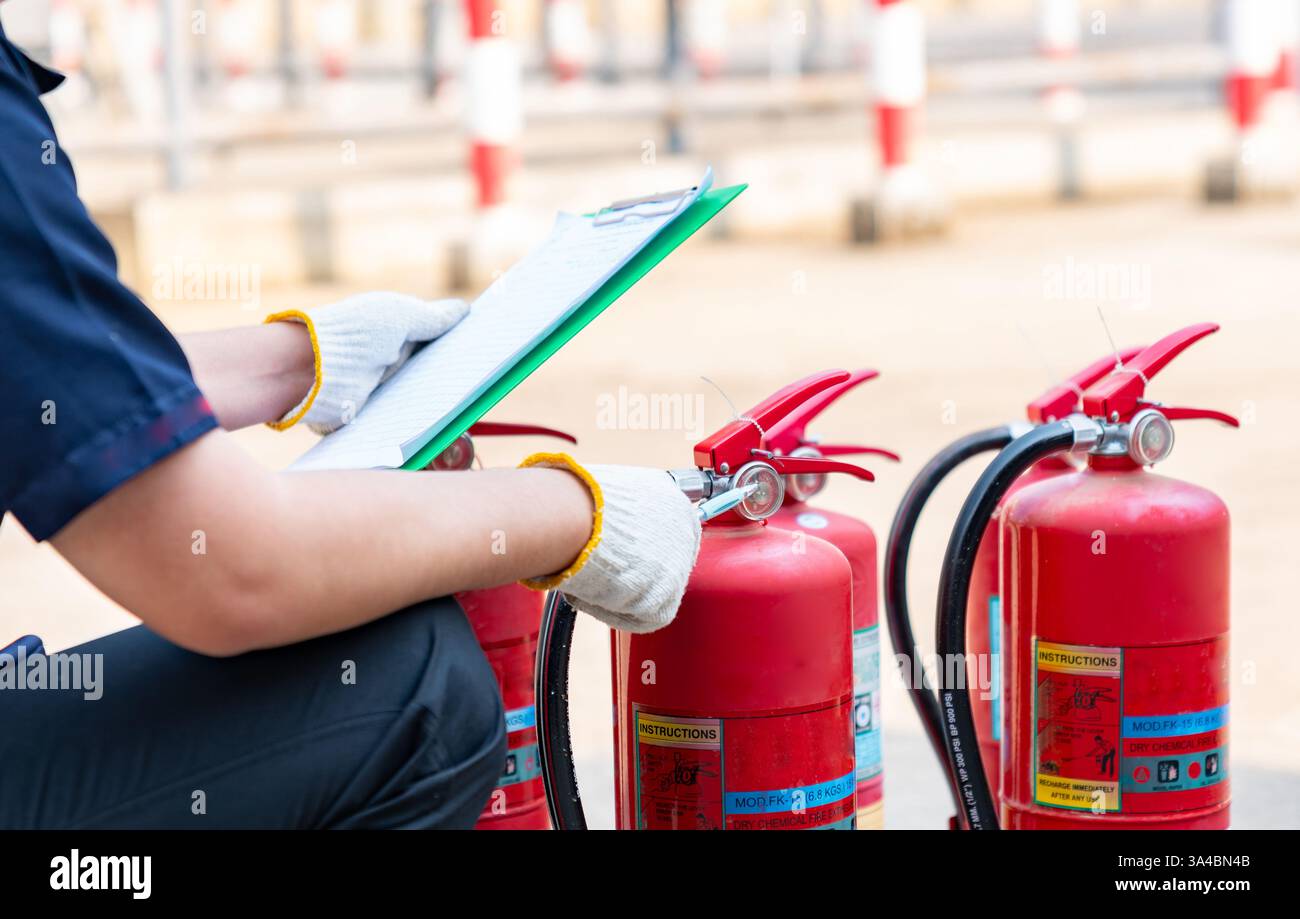 A safety officer inspector checks gauge indicates of the fire ...