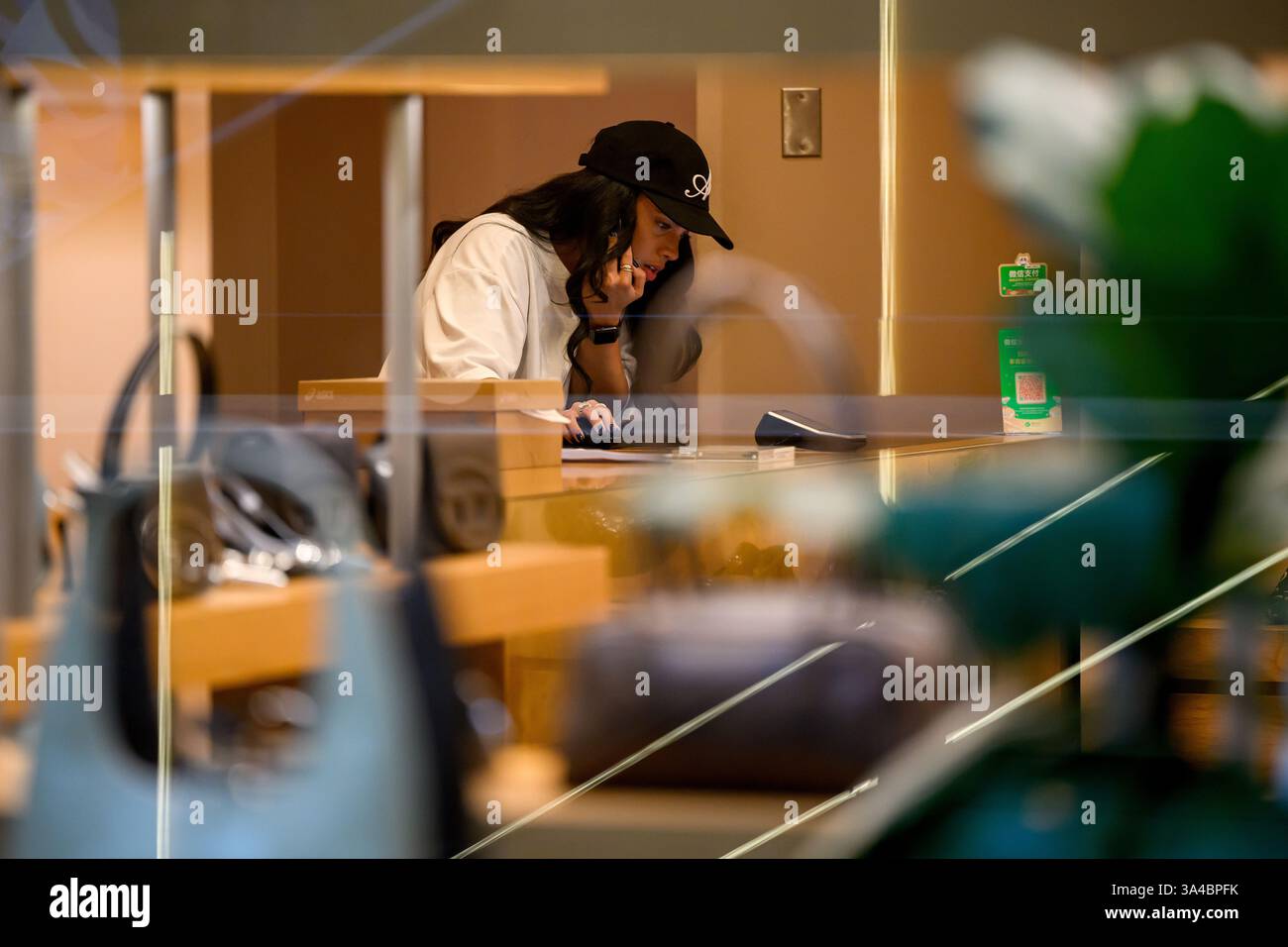 A female retail worker is seen at work in Sydney, New South Wales ...