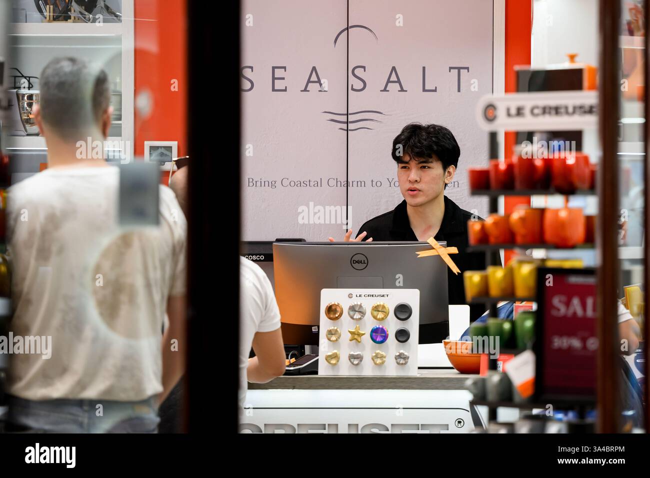 Sydney, Australia. 19th Mar, 2025. A male retail worker is seen at work in Sydney, New South ...