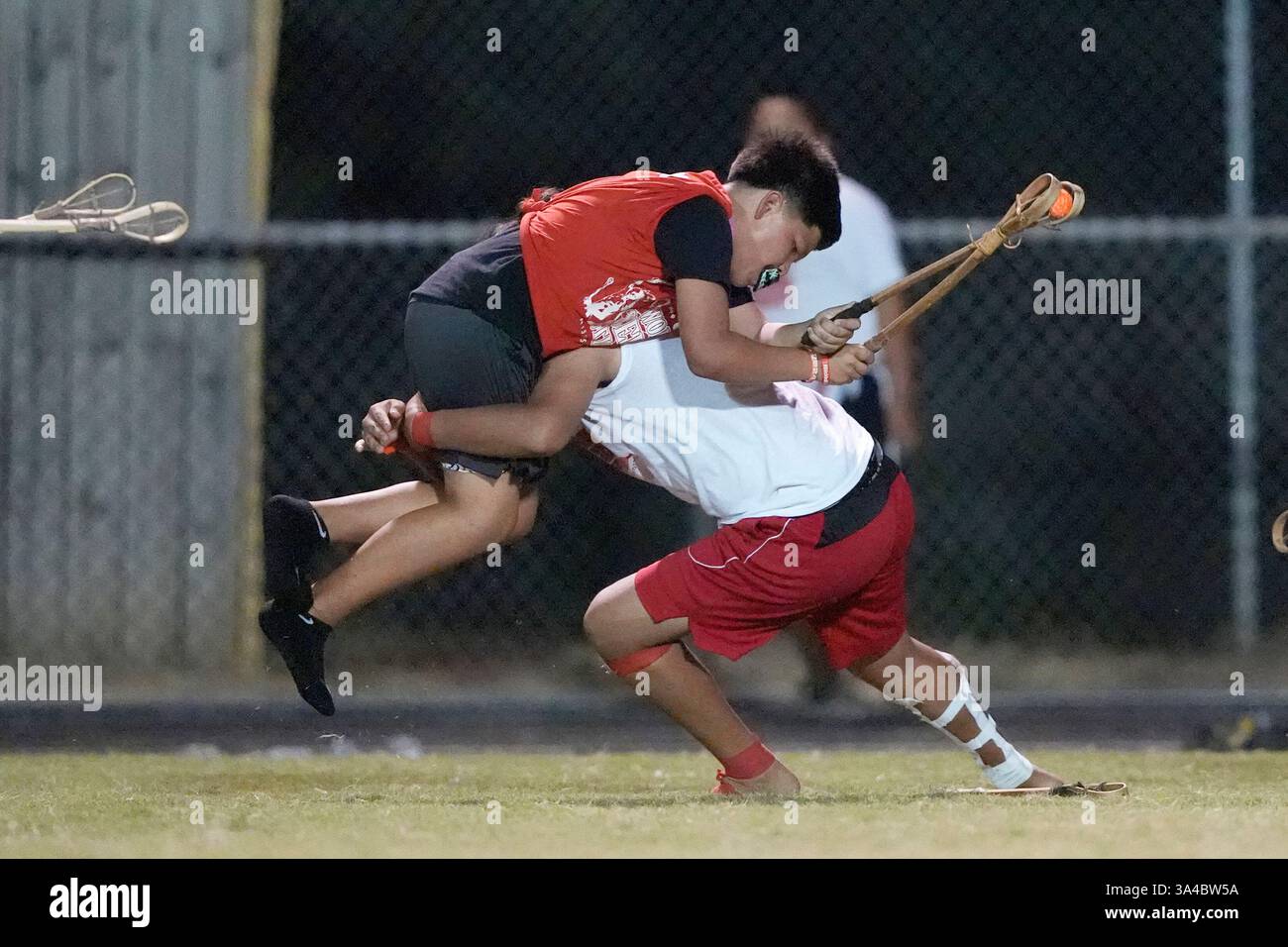 A Bok Cito player, right, loses his sticks as he tackles a Beaver Dam ...