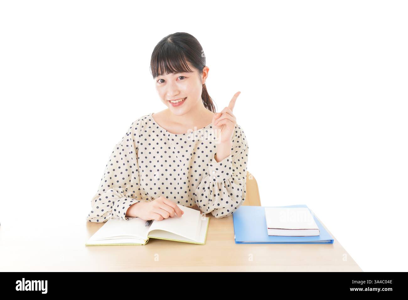 Young woman studying at desk Stock Photo - Alamy